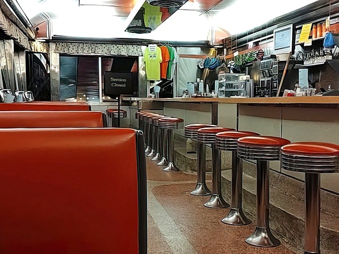 Red vinyl booths and chrome stools – the universal language of "sit down and stay awhile." Diner perfection in every detail.