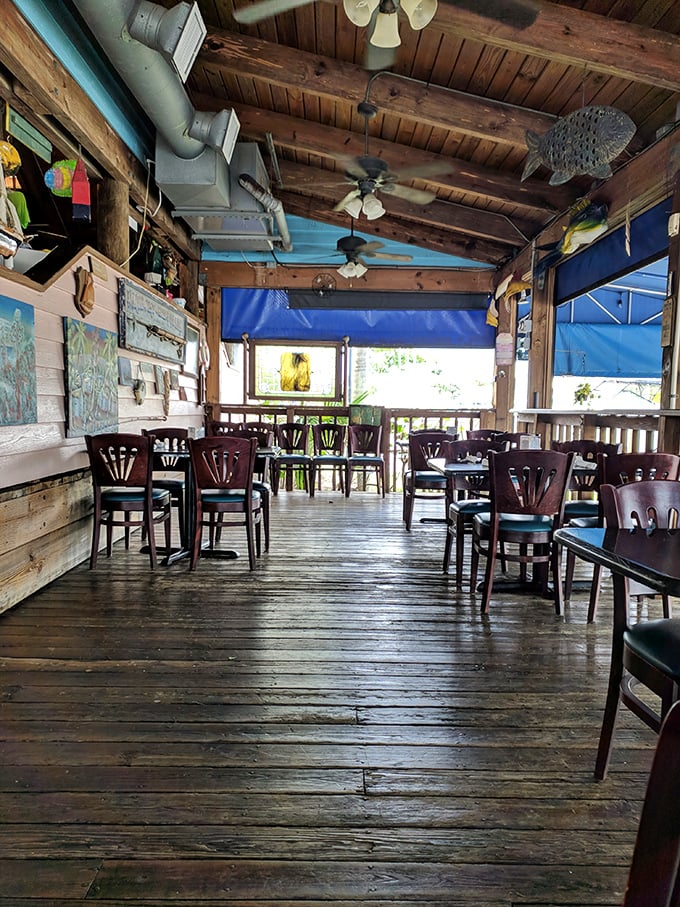 Weathered wooden beams tell stories overhead while sea-blue accents remind you exactly where you are. This isn't decoration—it's maritime autobiography.