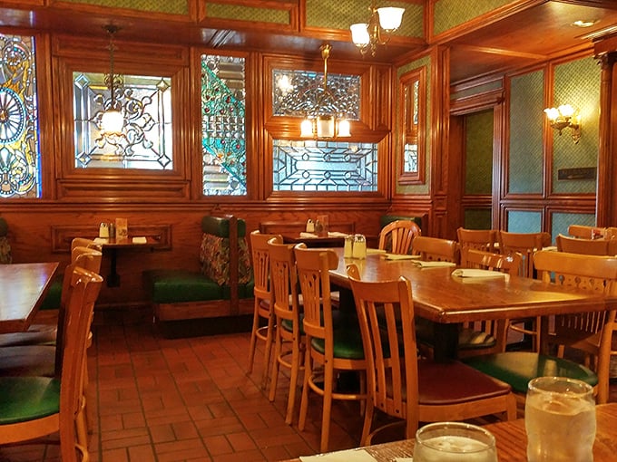 Step inside and time slows down – rich wood paneling, stained glass, and green upholstery create a sanctuary where breakfast is still sacred.