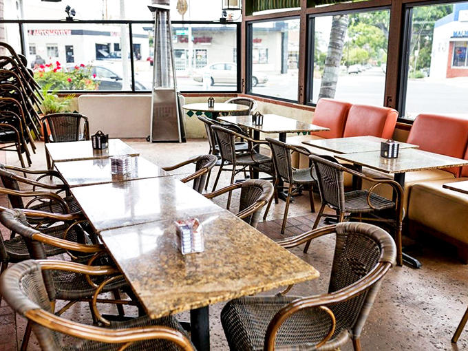 Sunlight streams through large windows, illuminating those classic woven chairs and granite tabletops—comfort never went out of style here.