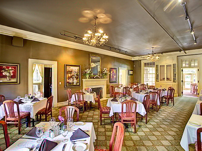 Elegant chandeliers cast a golden glow over white tablecloths, creating the perfect backdrop for food that deserves its own spotlight.