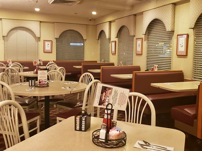 Inside, burgundy booths and arched windows create that perfect diner atmosphere—where conversations flow as freely as the coffee refills.