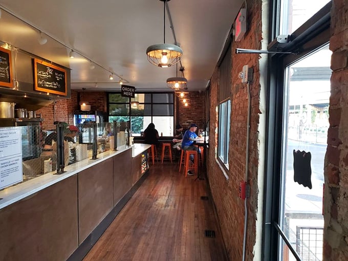 Industrial-chic meets cozy comfort inside, where exposed brick walls and warm lighting create the perfect backdrop for your fried chicken pilgrimage.