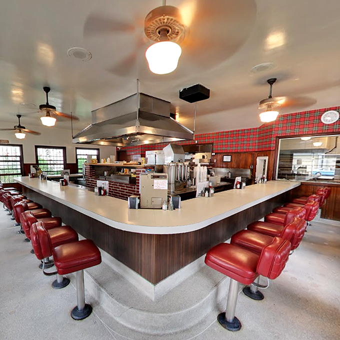 Step inside and you're transported to mid-century America – red vinyl counter stools, wood paneling, and the horseshoe counter where culinary magic happens.