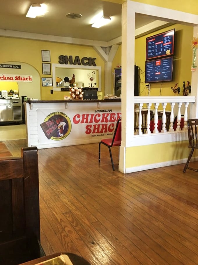 Sunny yellow walls and wooden floors create the perfect backdrop for chicken perfection. The digital menu boards promise delicious decisions ahead.