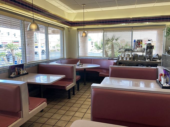 Classic burgundy booths and warm lighting create the perfect setting for contemplating life's big questions—like pancakes or waffles?