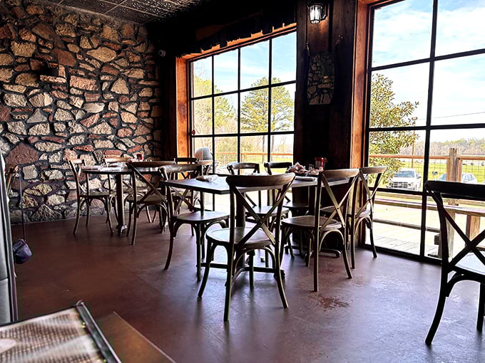 Stone walls and cross-back chairs create the perfect backdrop for river views—like dining in a cozy cabin that happens to serve legendary seafood.