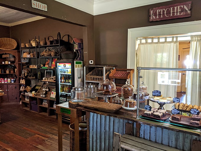 Behind this rustic counter lies a world of homemade delights, where glass domes protect treasures more valuable than gold – fresh-baked brownies.