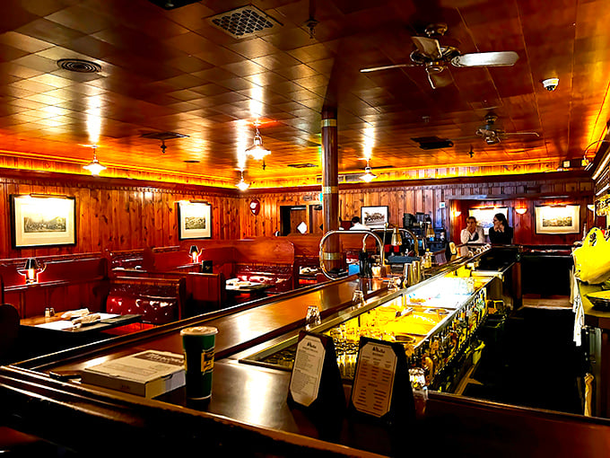 Step inside and time stands still – wood-paneled warmth, burgundy booths, and the amber glow that makes everyone look like they've been perfectly seared.
