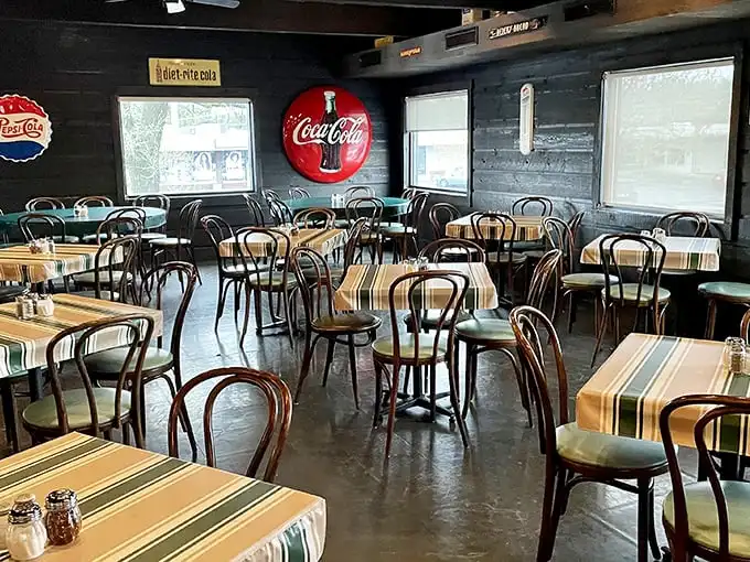 Step inside and time slows down – vintage Coca-Cola signs, bentwood chairs, and striped tablecloths create the pizza parlor equivalent of a warm hug.