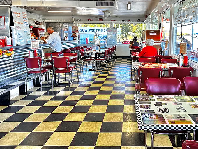 The checkerboard floor and cherry-red vinyl seats aren't retro by design—they're original, having witnessed decades of first dates, family outings, and food epiphanies.
