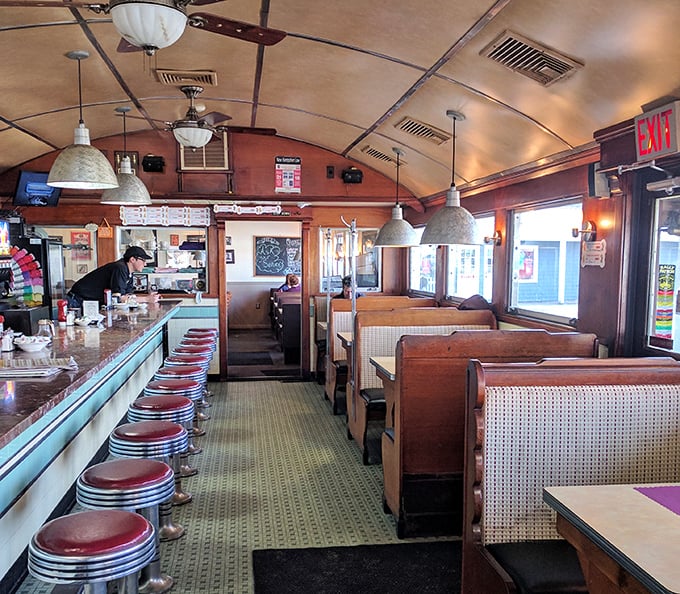 Step inside and time travel begins—curved ceiling, red vinyl stools, and booths that have cradled thousands of satisfied customers through countless coffee refills.