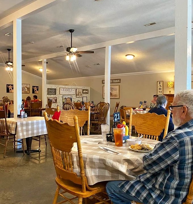Wooden chairs, checkered tablecloths, and ceiling fans spinning lazily overhead—this isn't just dining, it's time travel to Grandma's Sunday dinner.