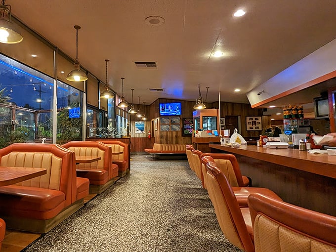 Those orange vinyl booths aren't just seating—they're front-row tickets to the greatest show on earth: breakfast served all day in a perfectly preserved slice of classic Americana.