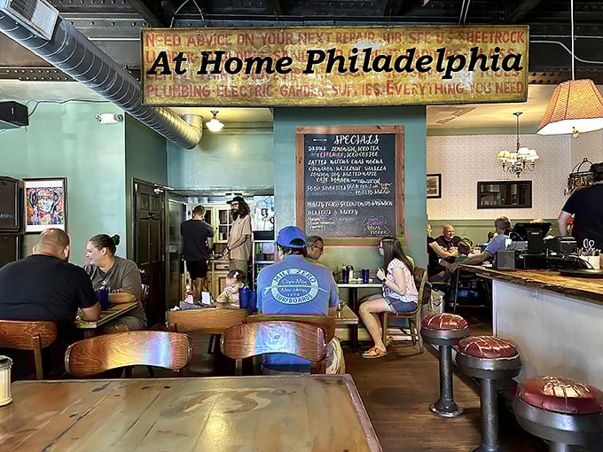 That "At Home Philadelphia" sign isn't kidding. The mint-green walls and vintage fixtures create the living room you wish served pancakes.