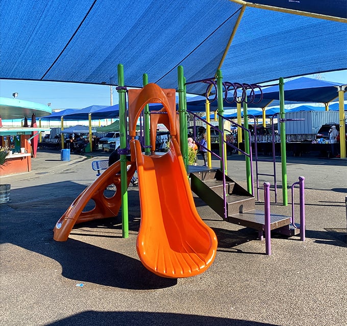 That beautiful orange slide isn't just for show—it's your secret weapon for keeping kids happy while you hunt for deals.
