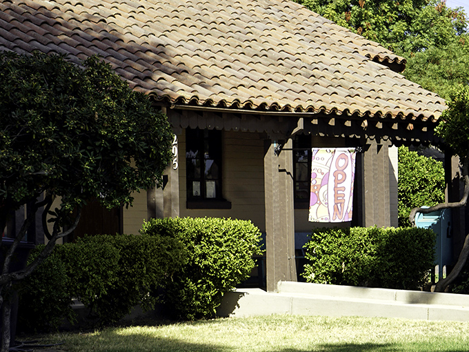 This charming Spanish-style cottage with its clay tile roof isn't just adorable—it's a reminder that "cozy" doesn't have to mean "can't afford anything bigger."