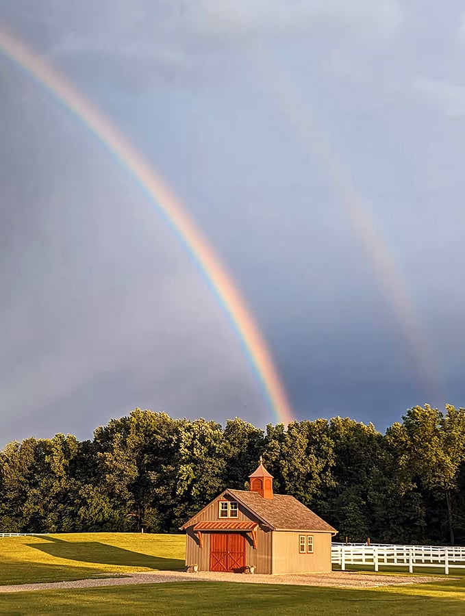 Nature's own light show! A perfect double rainbow arches over the barn, as if the universe itself is giving Erinwood Farms its seal of approval.