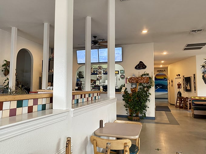 Clean white columns and colorful tiled accents create a cheerful coastal vibe. The nautical theme whispers rather than shouts—exactly as it should.
