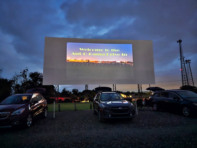"Welcome to the Aut-O-Rama Drive-In" glows against the twilight sky, a neon promise of nostalgia that actually delivers on its word.