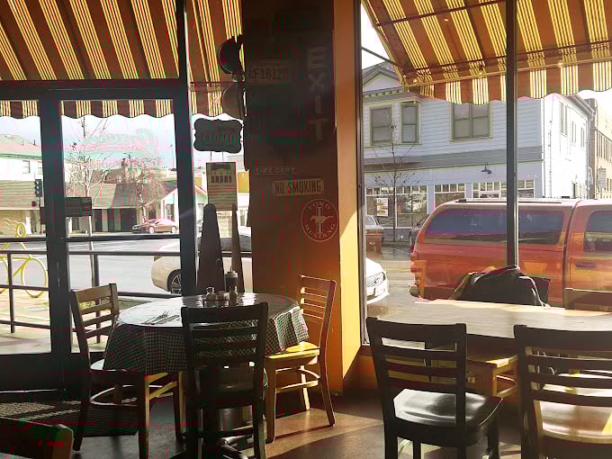 Checkered tablecloths and natural light create the perfect setting for the meat symphony that's about to unfold.