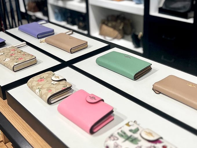 A rainbow of designer wallets awaits new homes. That mint green one is practically begging to hold your credit card for its next shopping adventure.