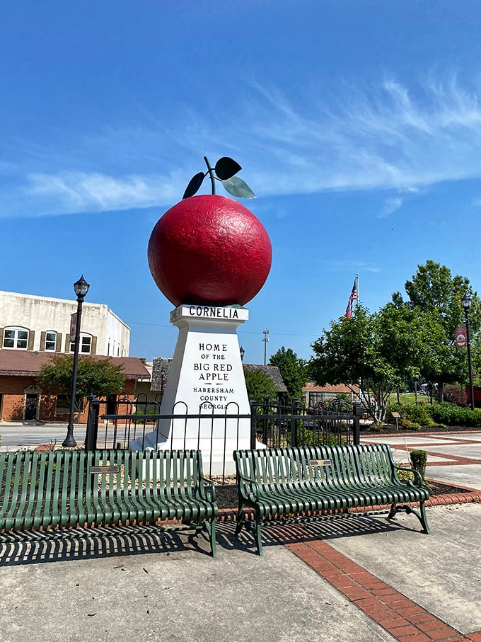 Green benches invite visitors to sit and contemplate life's big questions, like "Who thought of making an apple this enormous?"