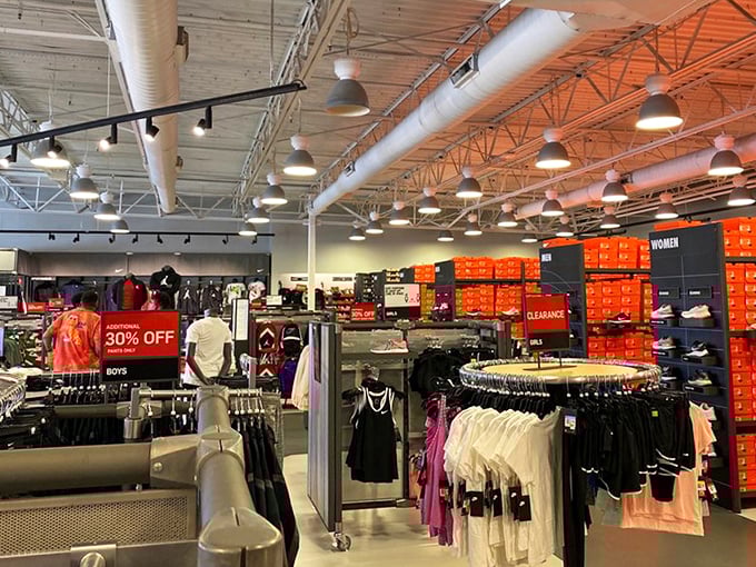 The Nike outlet's impressive wall of orange shoeboxes—like a monument to fitness aspirations and weekend warrior dreams.