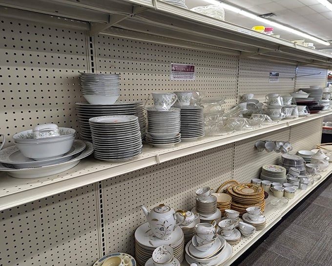 Perfectly stacked white dinnerware awaits new homes – one person's castoff becomes another's complete dinner service for that long-planned family gathering.