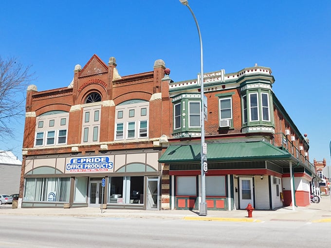 The E-Pride Office Products building showcases the town's preserved architectural heritage, with distinctive green accents that pop against the classic brick façade.