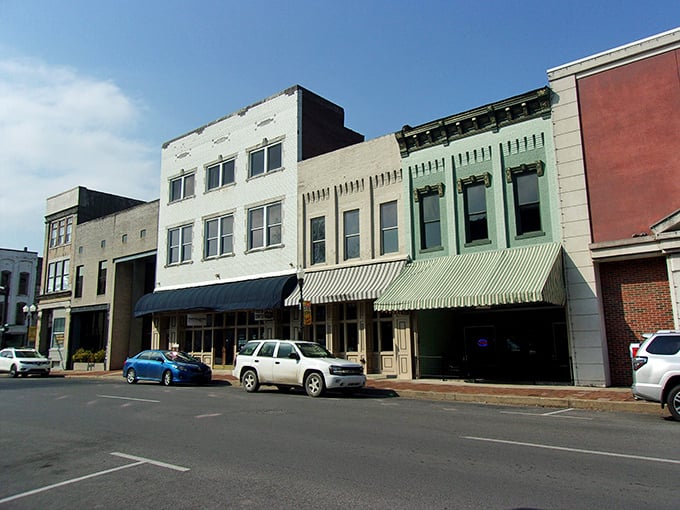 These colorful storefronts aren't just buildings—they're time capsules with awnings, where small-town commerce has thrived for decades. 