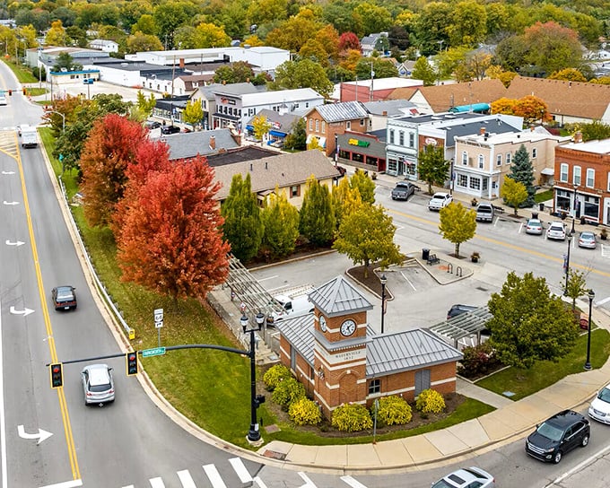 The clock tower anchors downtown Waterville, where fall foliage creates a natural fireworks display that no smartphone camera can truly capture.