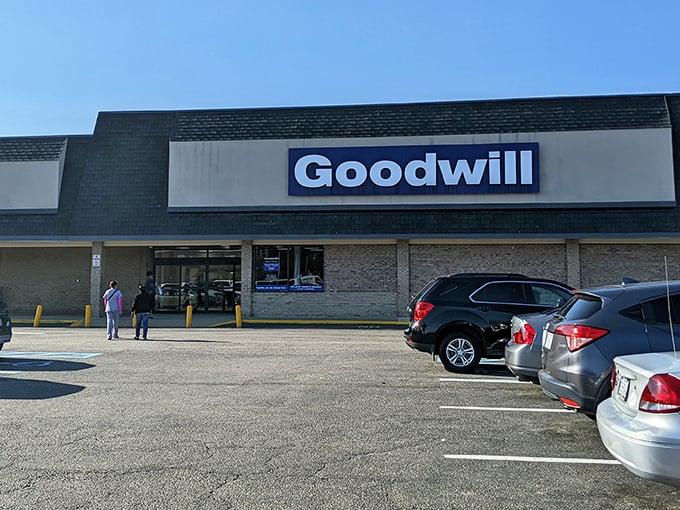 The unassuming storefront hides a universe of possibilities within—like finding the Narnia of secondhand shopping behind these ordinary glass doors.