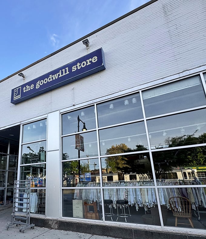 Blue signage against crisp white brick—like a portal to another dimension where designer labels don't require a second mortgage.
