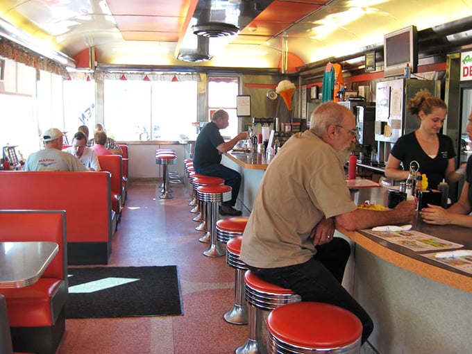The classic counter-and-booth setup—where strangers become neighbors and regulars become family. Democracy in action, one coffee refill at a time.