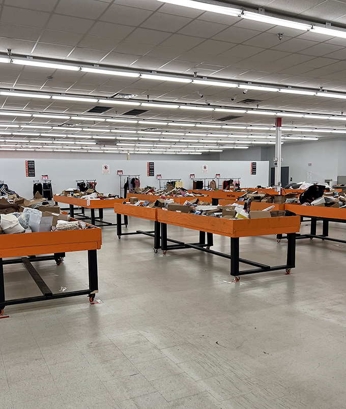 Orange bins stretch across the floor like a sea of potential discoveries—retail archaeology at its most democratic.