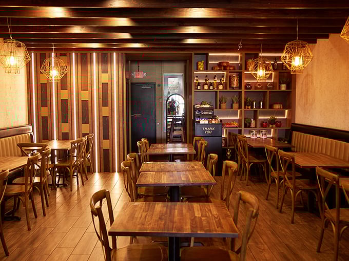 Warm wooden beams and thoughtful lighting create the perfect backdrop for the food drama about to unfold on your table.