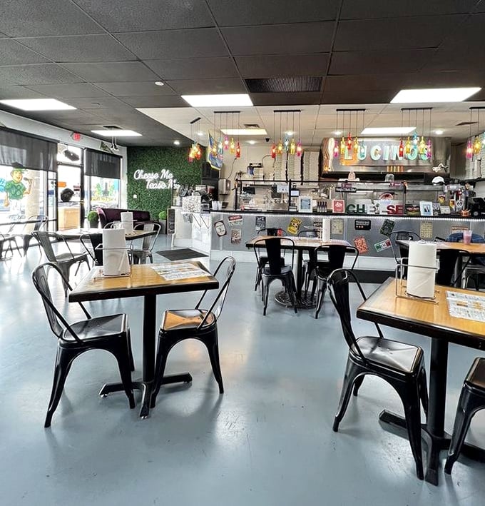 Inside, modern industrial meets cozy pizzeria. The "Cheese Me, Tease Me" neon sign isn't just decor – it's a promise they deliver on.