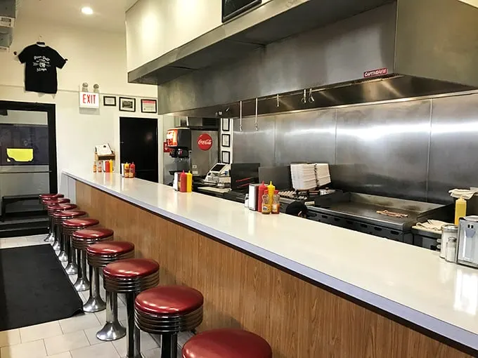Classic red vinyl stools lined up like soldiers, ready for the next wave of hungry patrons seeking solace in eggs and coffee.