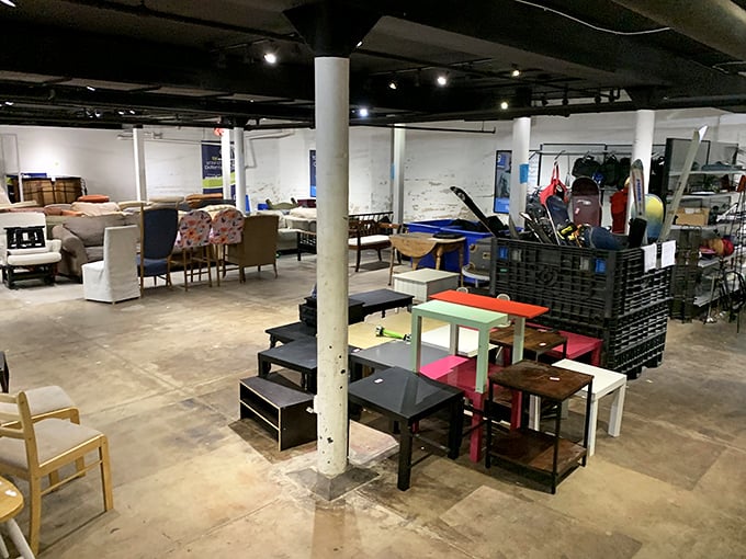 A thrifter's paradise unfolds inside with colorful furniture islands and endless possibilities. Even the support columns seem to stand in amazement.