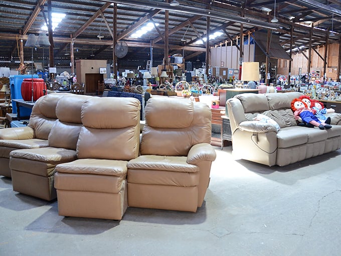 A sea of comfortable seating options stretches across the warehouse floor—each couch with its own story and ready for its next chapter.