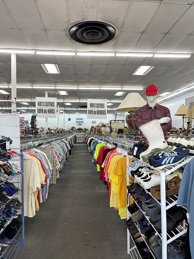 Organized chaos at its finest—rows of color-coded clothing stretch toward the horizon like a rainbow road map to style salvation.