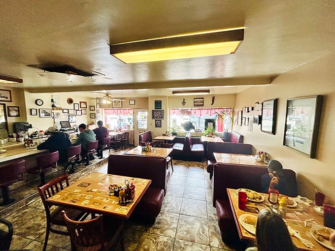 Classic diner ambiance with burgundy booths where strangers become friends and regulars are treated like royalty—the breakfast club everyone wants to join.