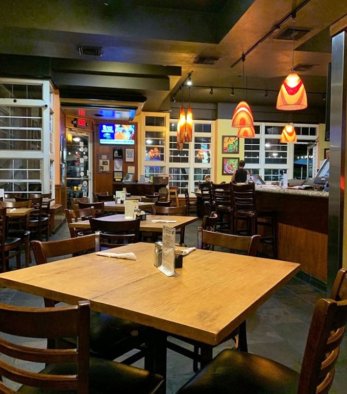 Warm wooden tables bathed in the glow of distinctive orange pendant lights create that rare atmosphere—sophisticated yet completely unpretentious.