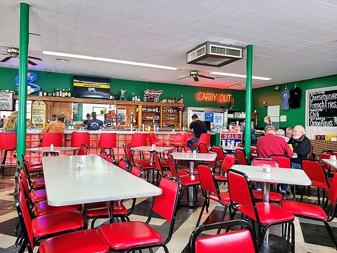 Red vinyl chairs and green walls create the perfect backdrop for serious eating – no Instagram filters required for this authentic diner experience.