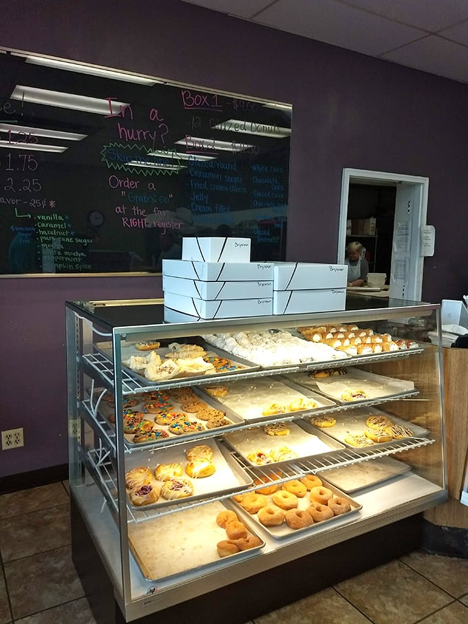 Behind the counter, Milton's display case showcases the morning's fresh batch—a museum of fried dough masterpieces that won't last long.