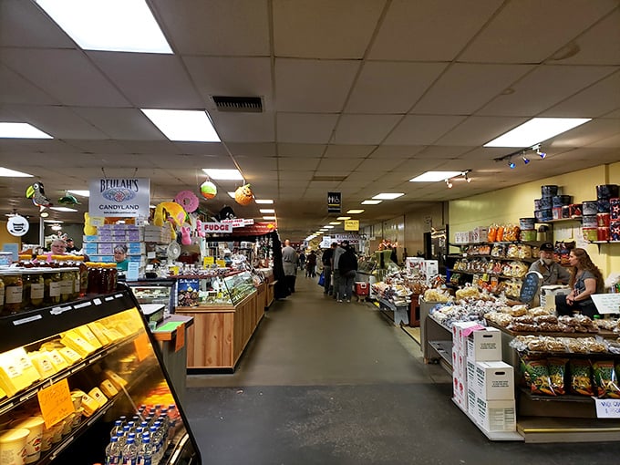 The indoor market corridor feels like a food lover's fever dream—candy displays, baked goods, and snacks stretching as far as the eye (and waistband) can see.