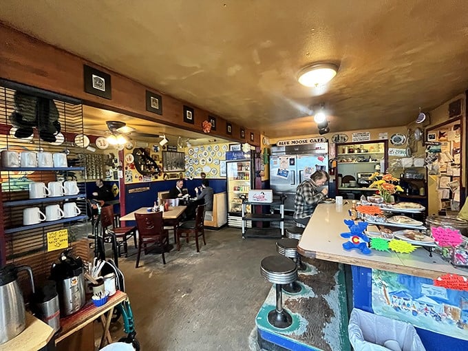 Inside, every inch tells a story – mismatched mugs, wood-paneled walls, and the kind of cozy chaos that says "the food matters more than the decor."