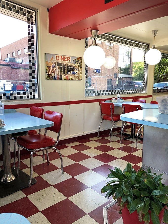 Red and white checkerboard floors, chrome accents, and vinyl chairs—this isn't retro-themed, folks. It's the real deal that never went out of style.