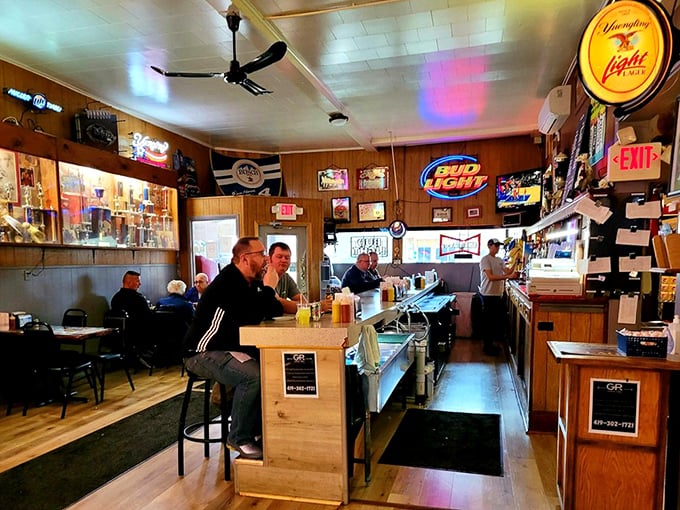 Inside, wood paneling and neon beer signs create the perfect time capsule – a place where conversations flow as freely as the drinks.